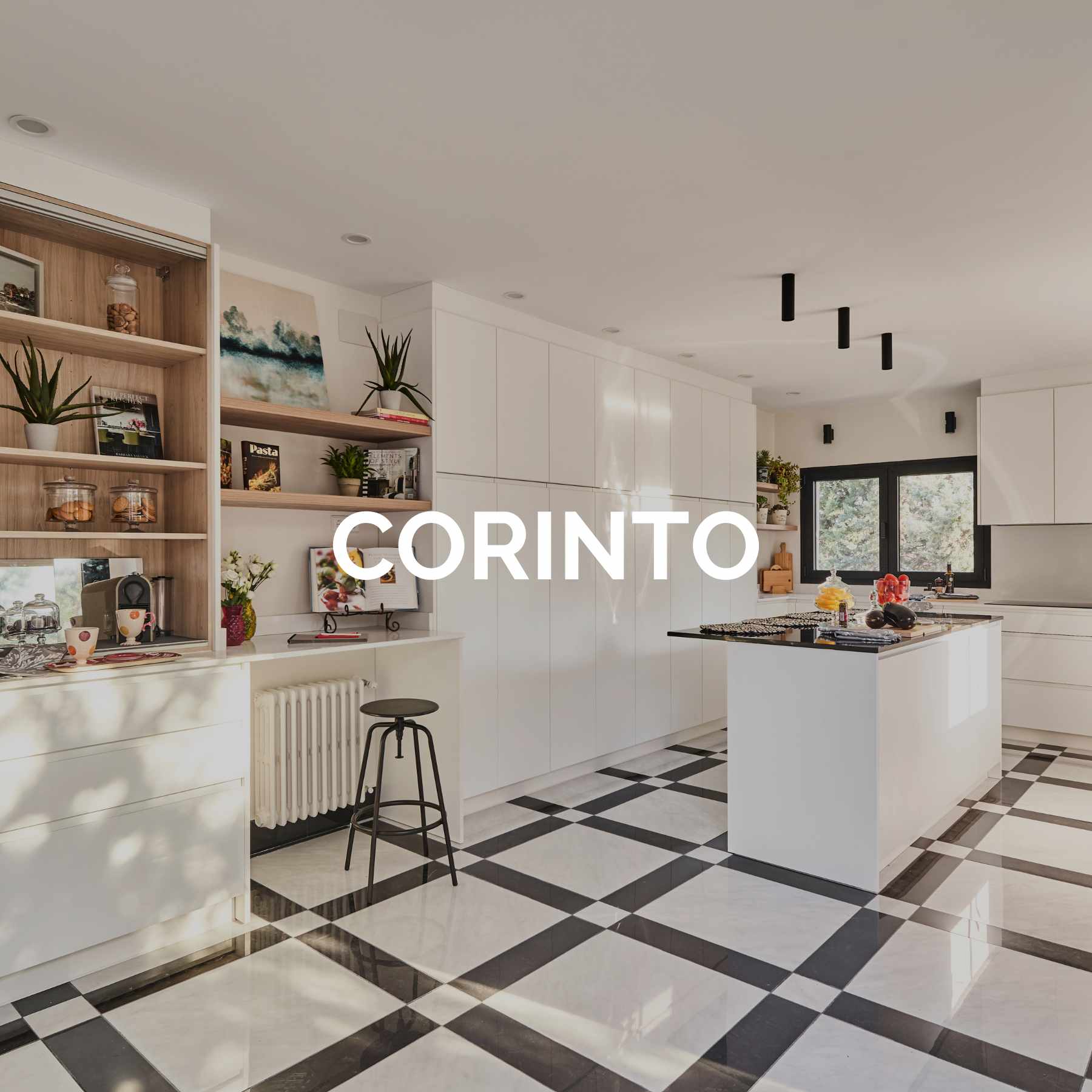 Cocina con isla blanca y encimera negra - Grupo Coeco